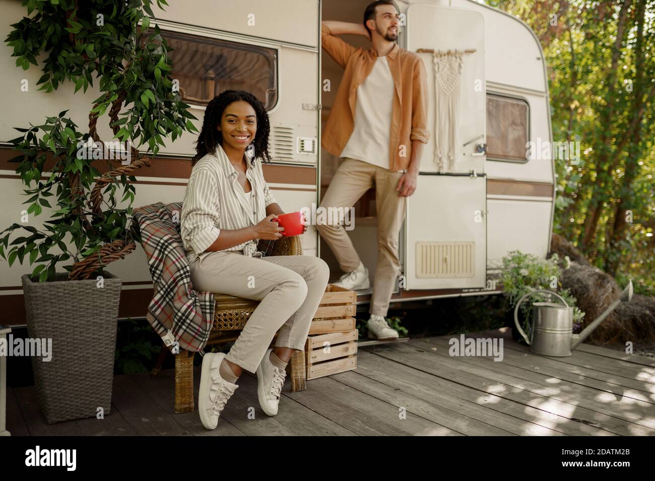 Love couple relaxing in rv, camping in a trailer Stock Photo - Alamy