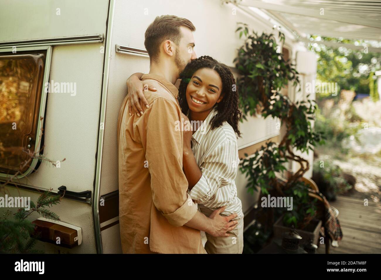 Love couple embraces in rv, camping in a trailer Stock Photo - Alamy