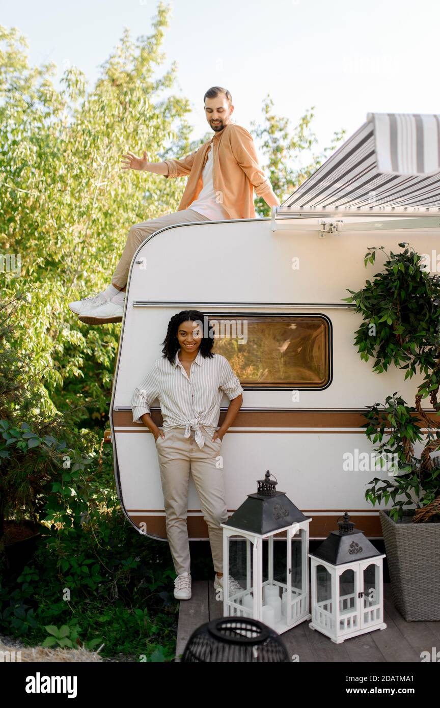 Happy couple poses near rv, camping in a trailer Stock Photo - Alamy