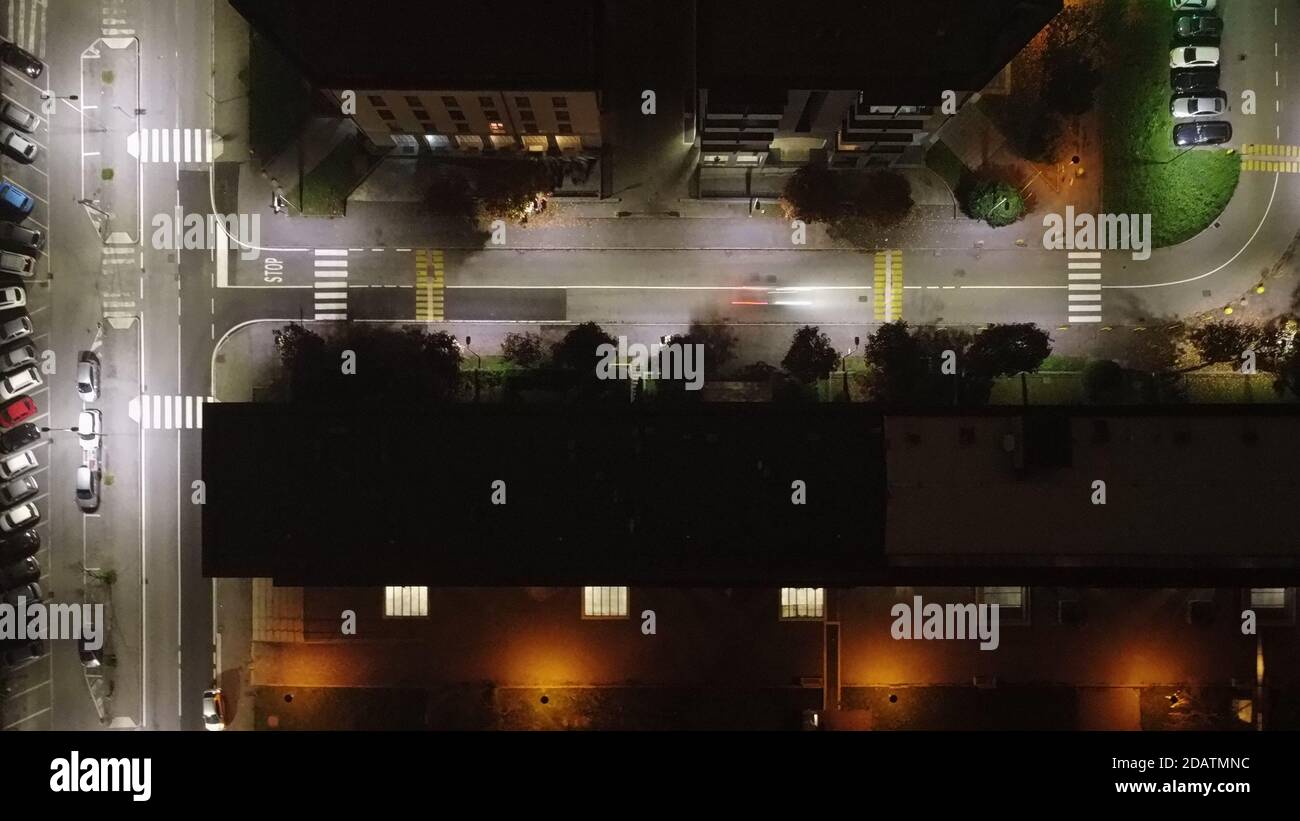 Aerial view of a city district illuminated by night lights, a drone ...