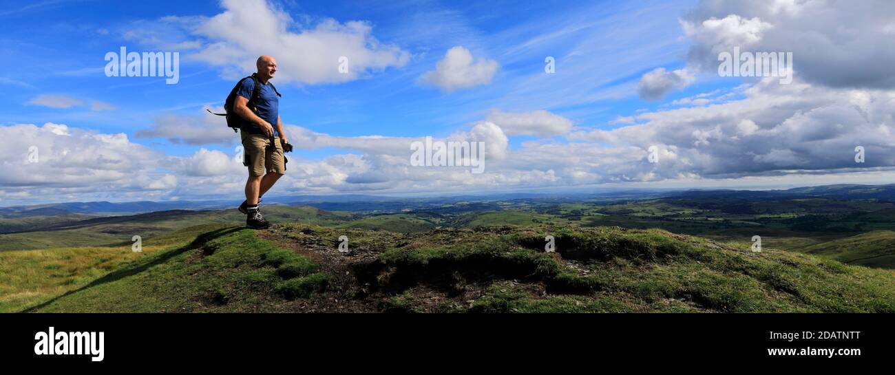 Walker at the Summit Cairn of Sallows fell, valley, Kirkstone pass ...