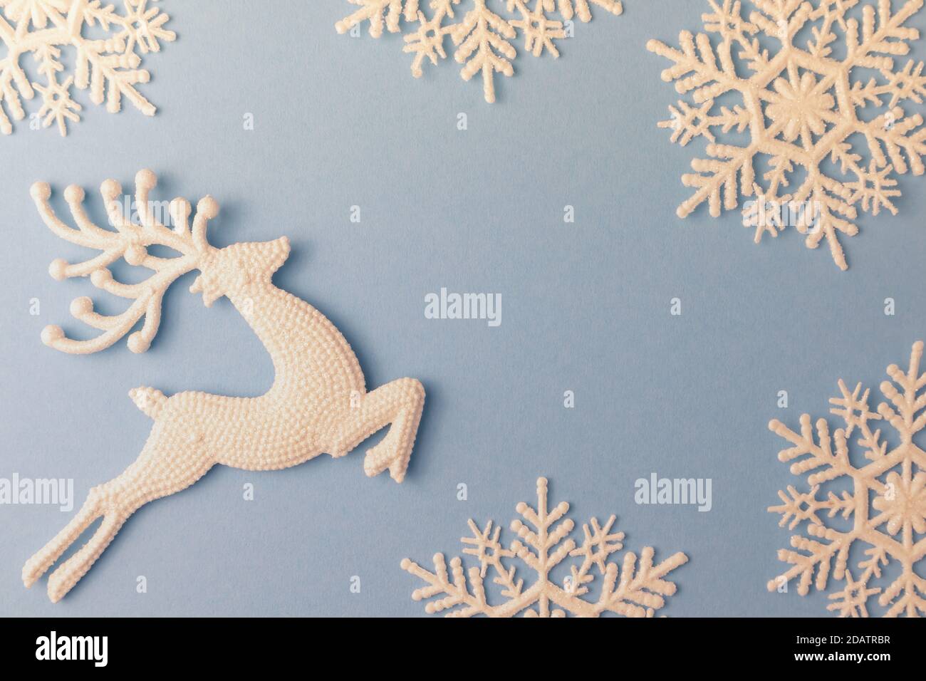 Snowflakes and deer for New Year's decor on a blue background with ...