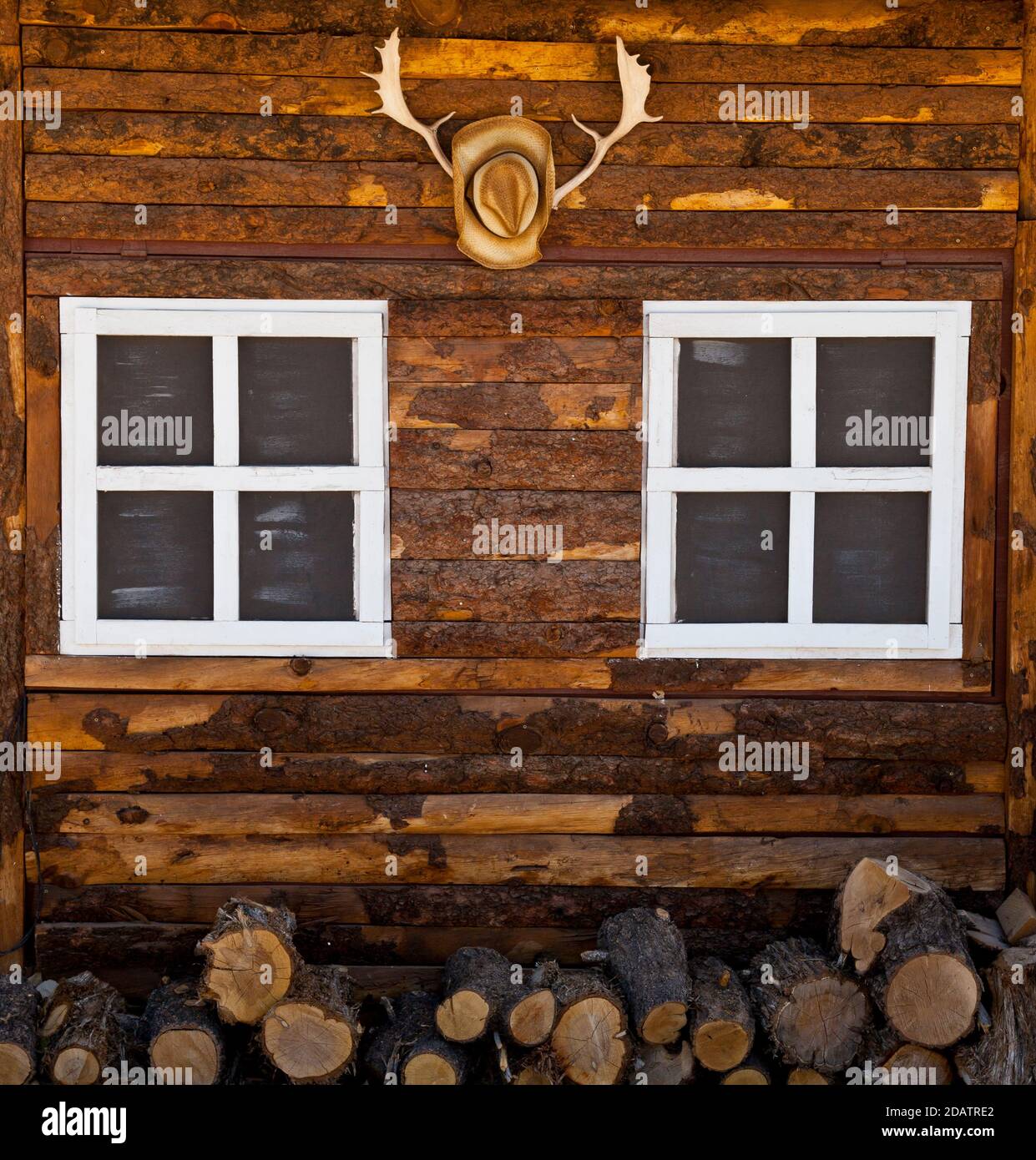 A cowboy hat hangs on the wall of a log cabin in Utah Stock Photo - Alamy