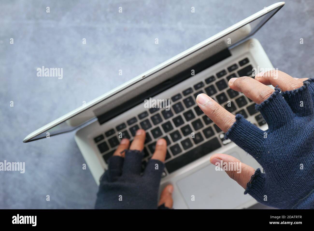 hacker hand stealing data from laptop top down Stock Photo - Alamy