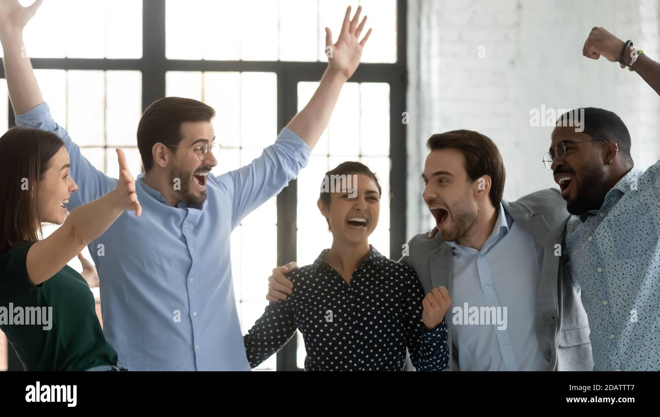 Happy multiethnic business team screaming in delight finishing great ...