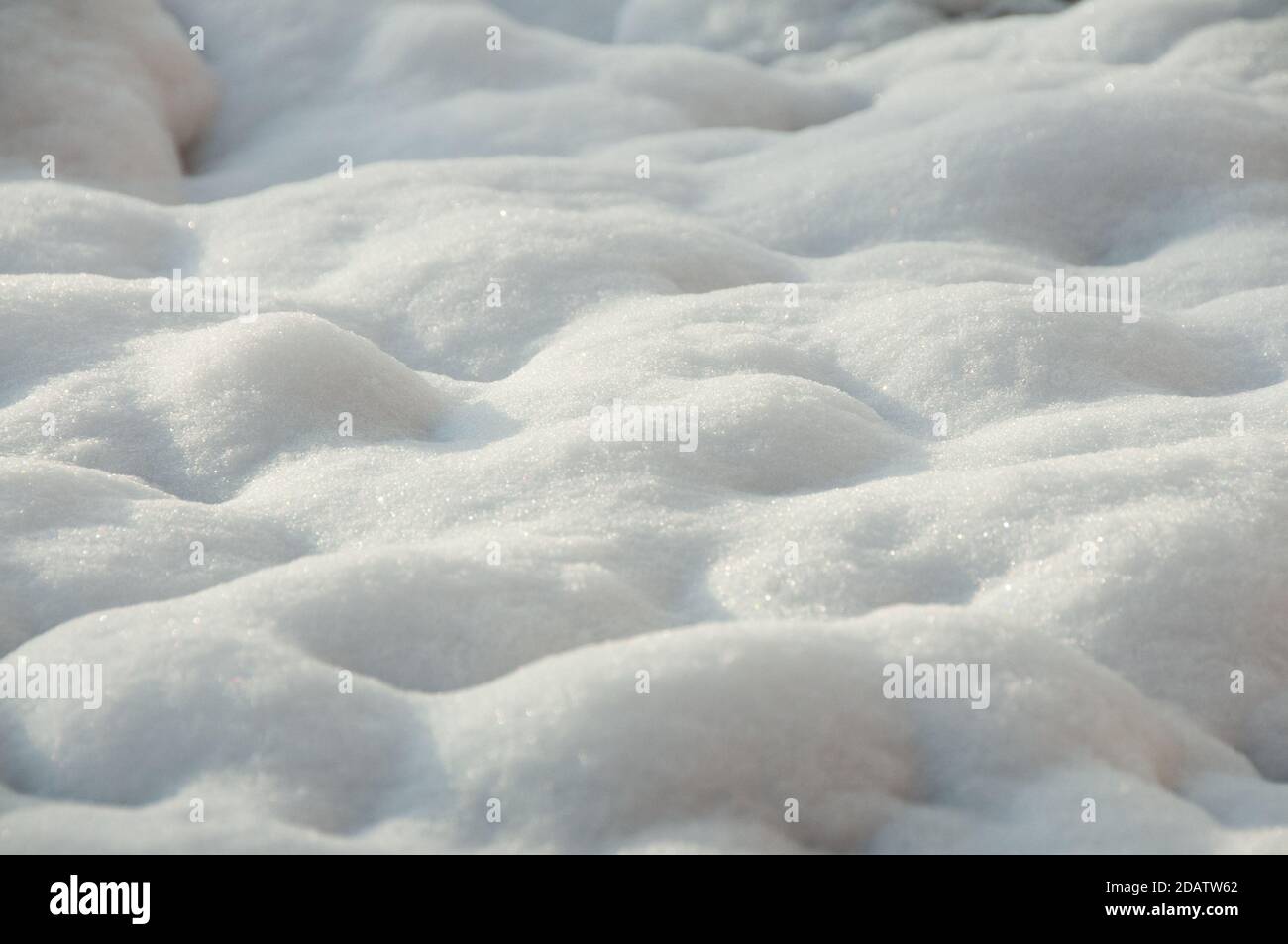 Close up of fresh snow forming some ripples on the ground Stock Photo ...