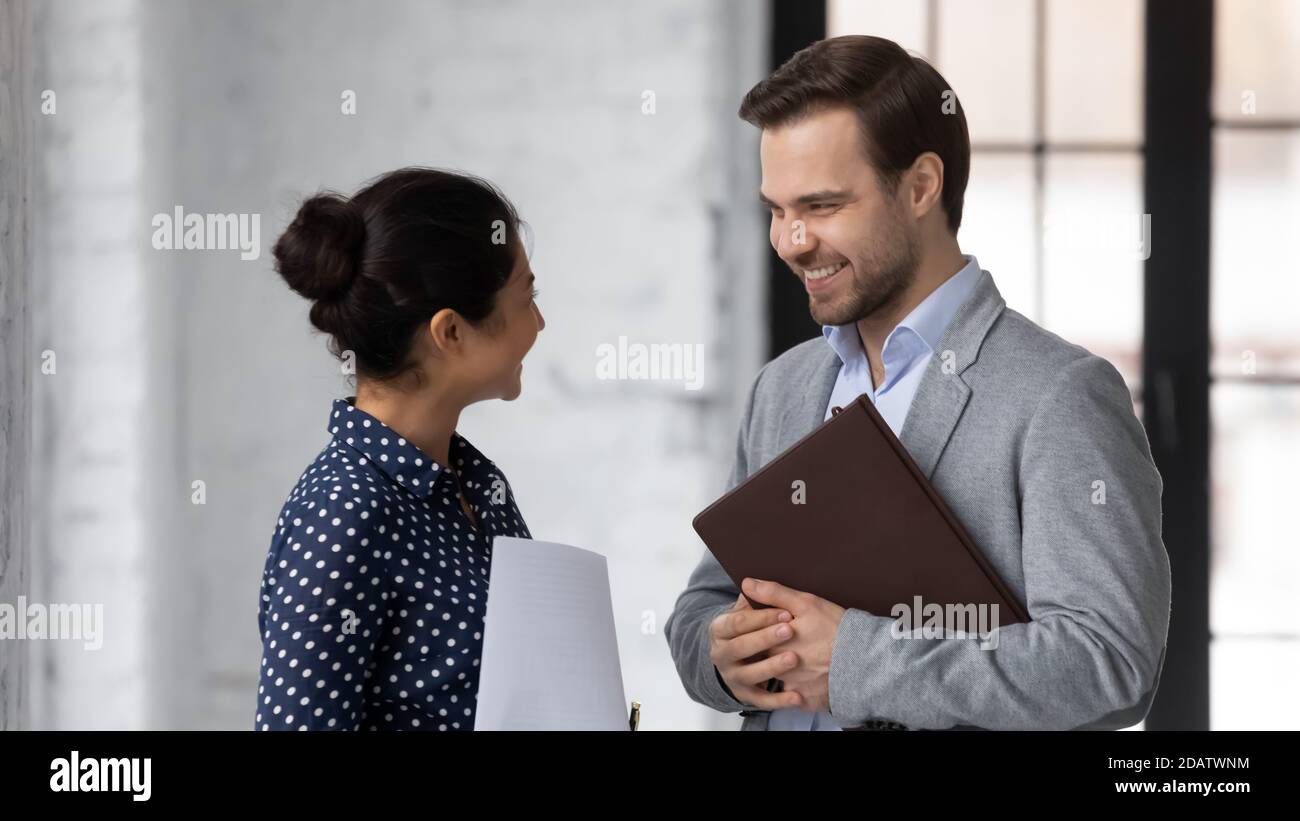 Talking young male colleague hi-res stock photography and images - Alamy