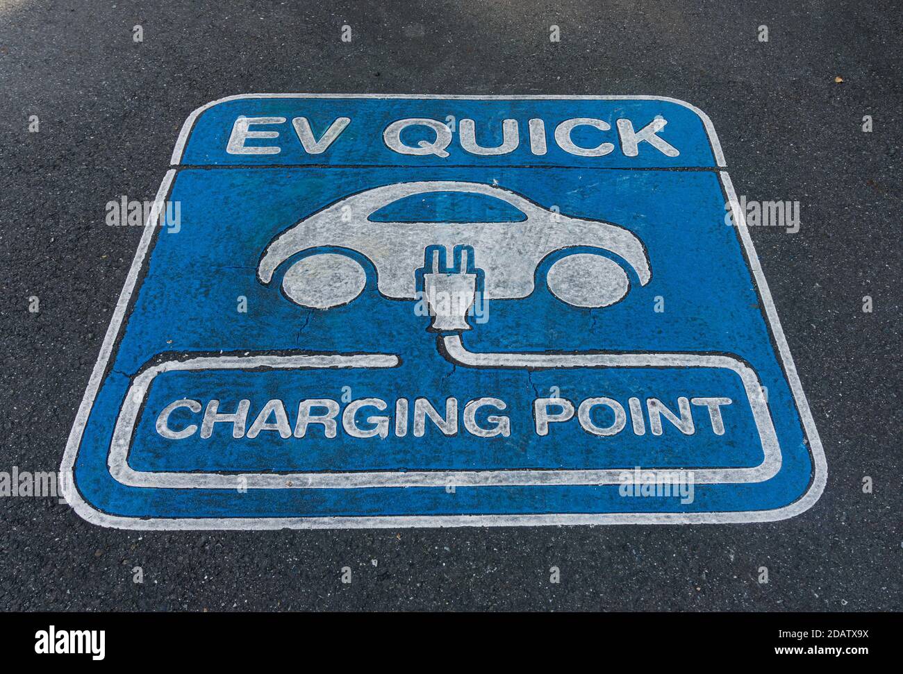 Blue sign on the ground for an EV Quick electric vehicle charging ...