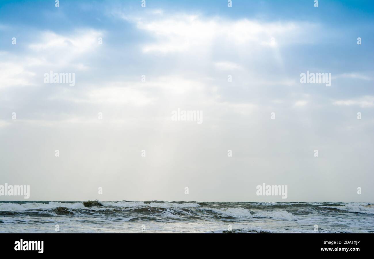 Sunshine pouring over the sea through the clouds view from beach of ...