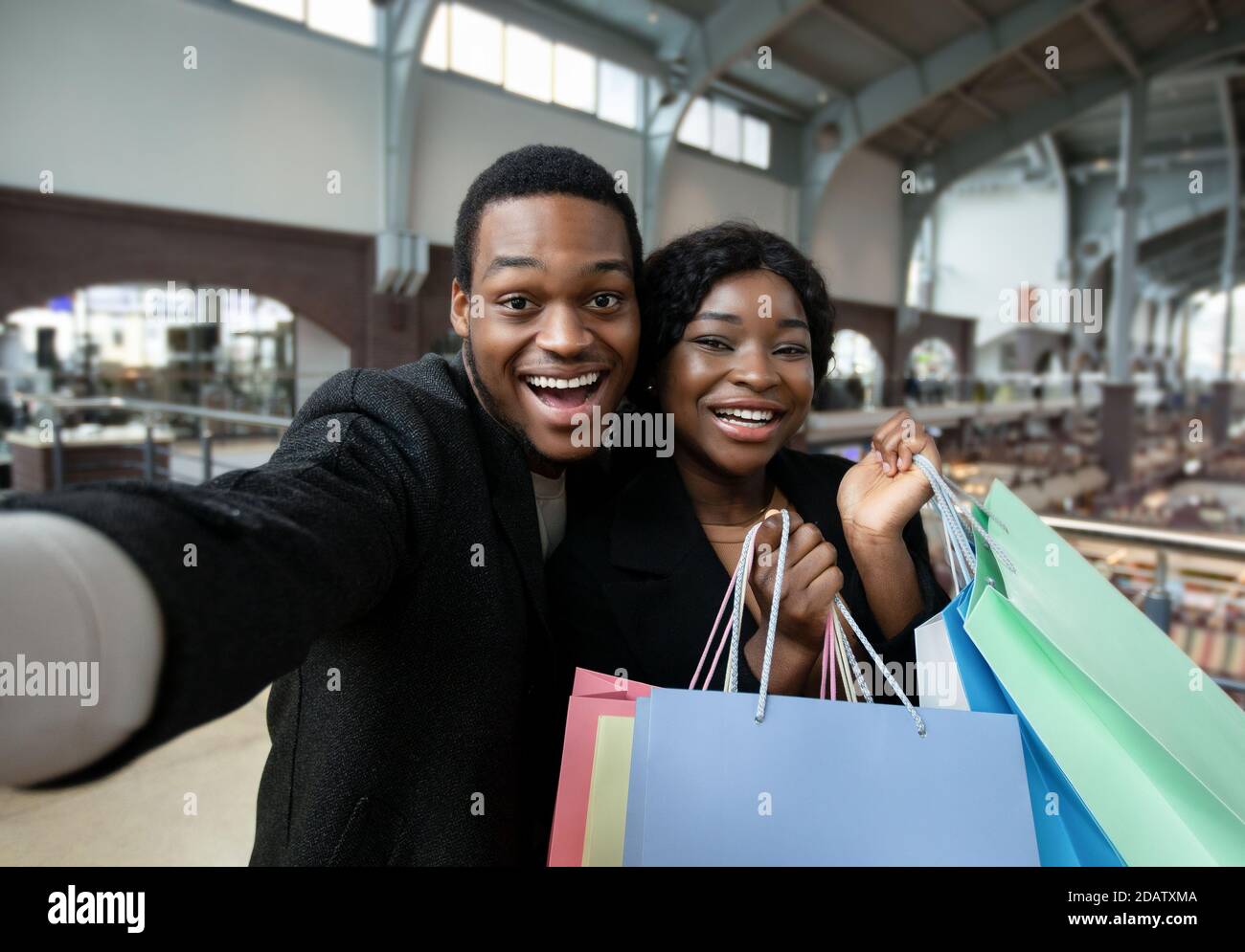 Amorous dates with shopping bags in modern city mall Stock Photo - Alamy