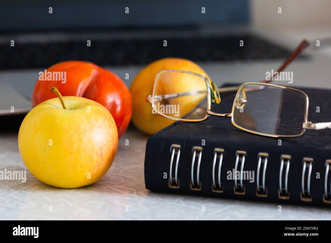Lunch break at the workplace in the office. Fruit glasses notepad ...