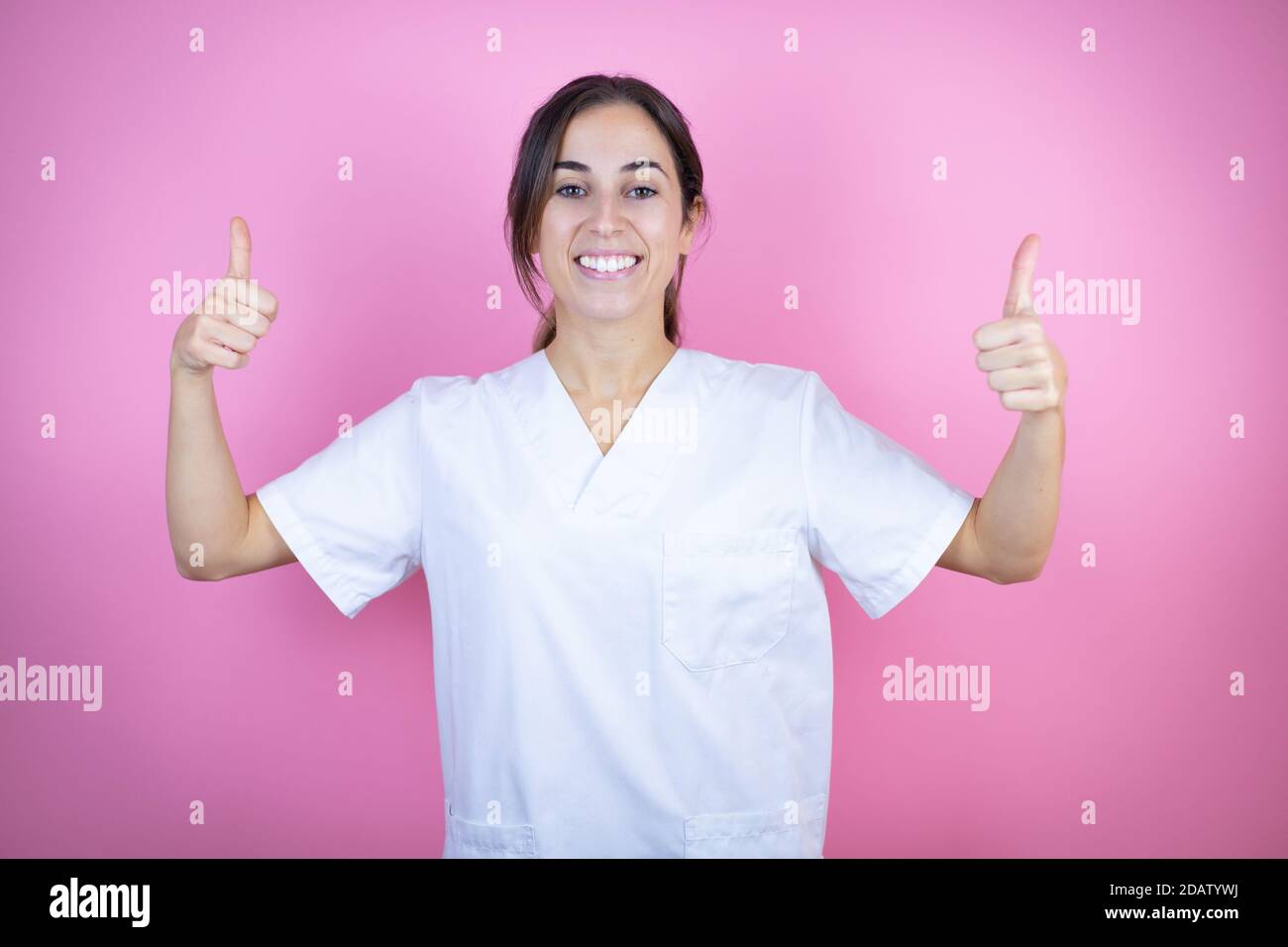 Young brunette doctor girl wearing nurse or surgeon uniform over ...