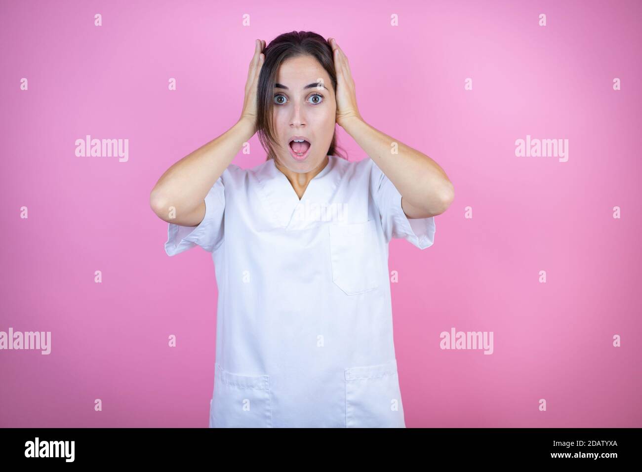 Young brunette doctor girl wearing nurse or surgeon uniform over ...