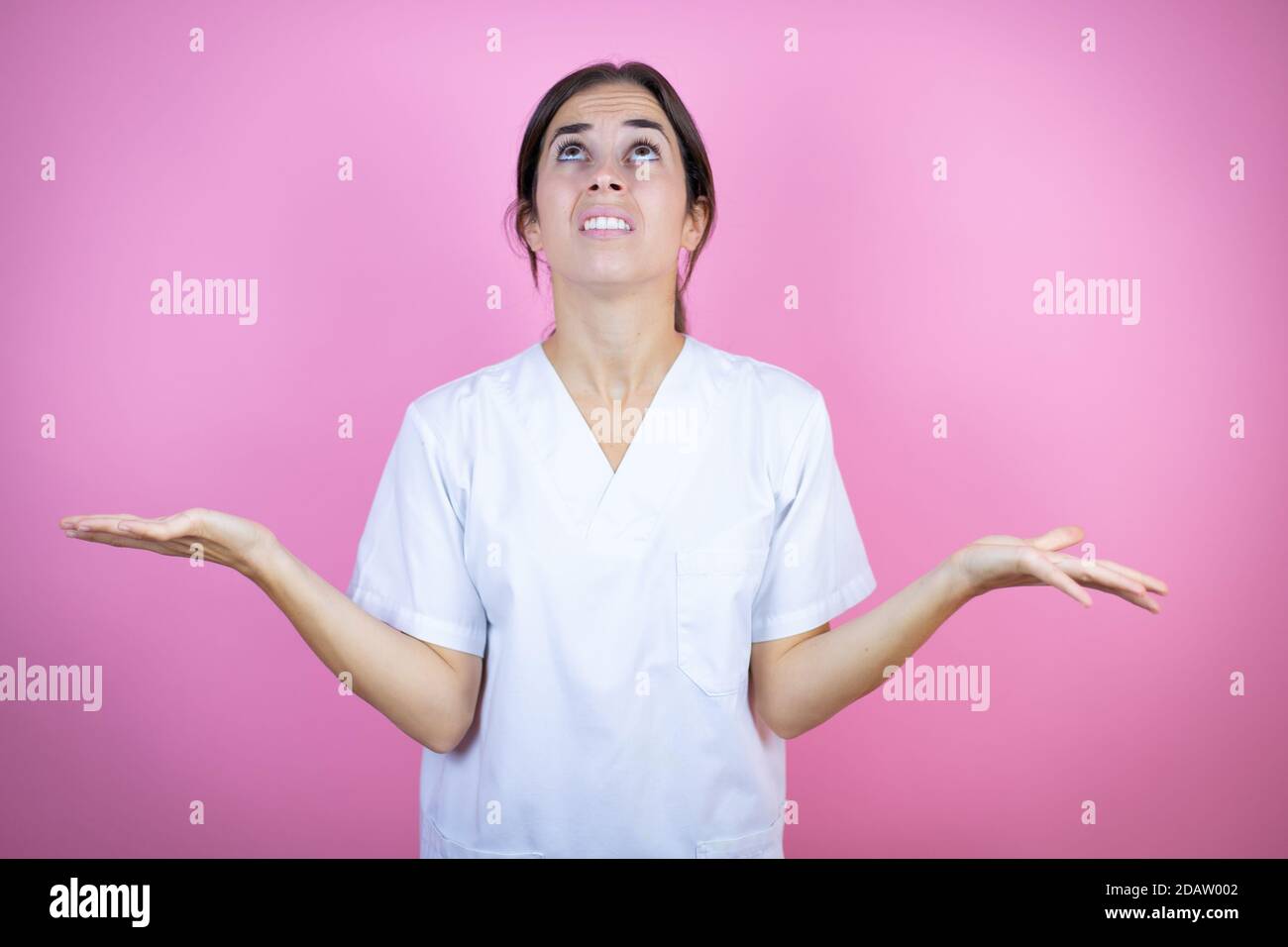 Young brunette doctor girl wearing nurse or surgeon uniform over ...
