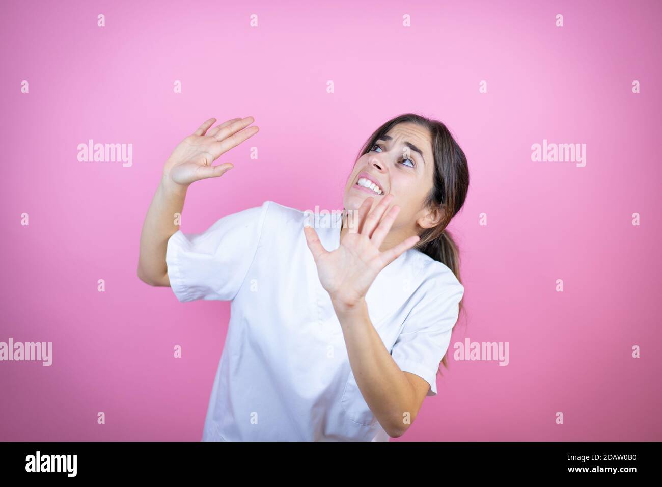 Young brunette doctor girl wearing nurse or surgeon uniform over ...