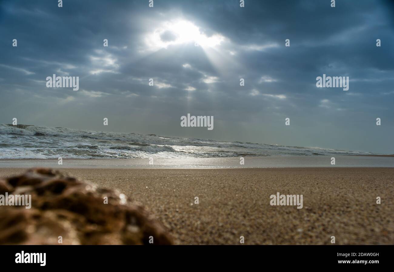 Sunshine pouring over the sea through the clouds view from beach of ...