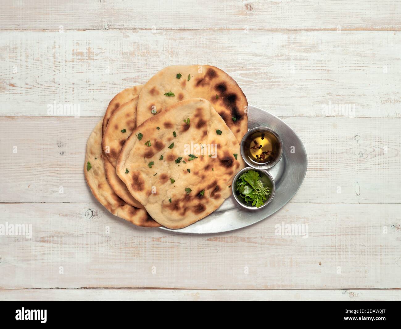Fresh naan bread on white wooden background with copy space. Top view ...
