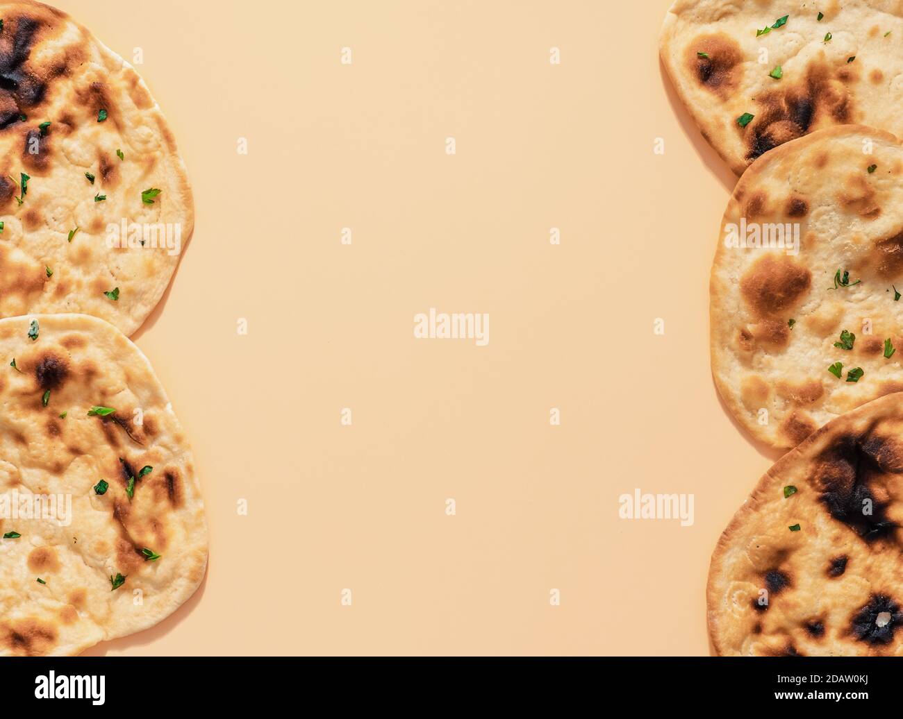 Pattern of fesh naan bread on yellow cream background with copy space ...