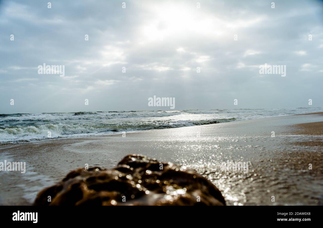 Sunshine pouring over the sea through the clouds view from beach of ...