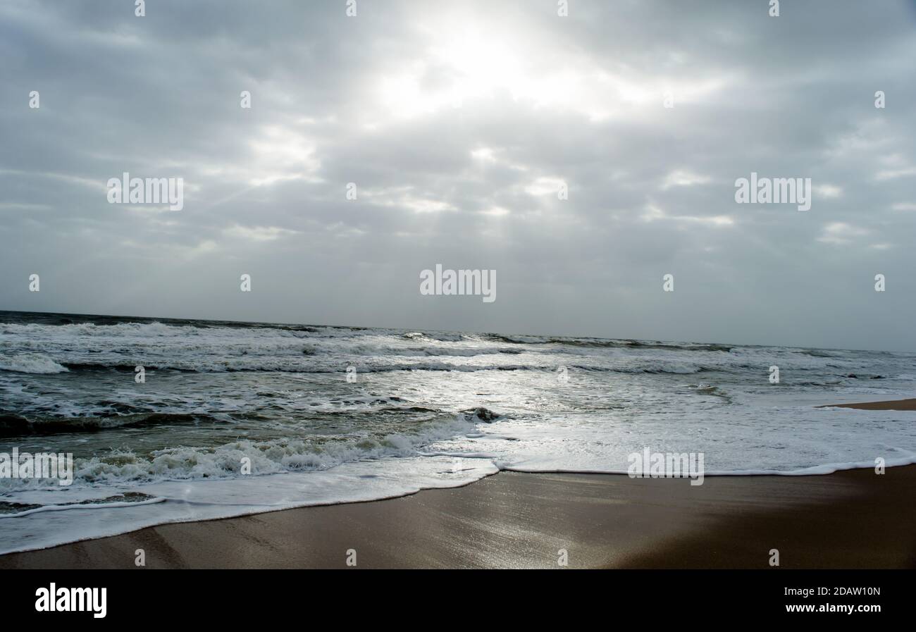 Sunshine pouring over the sea through the clouds view from beach of ...