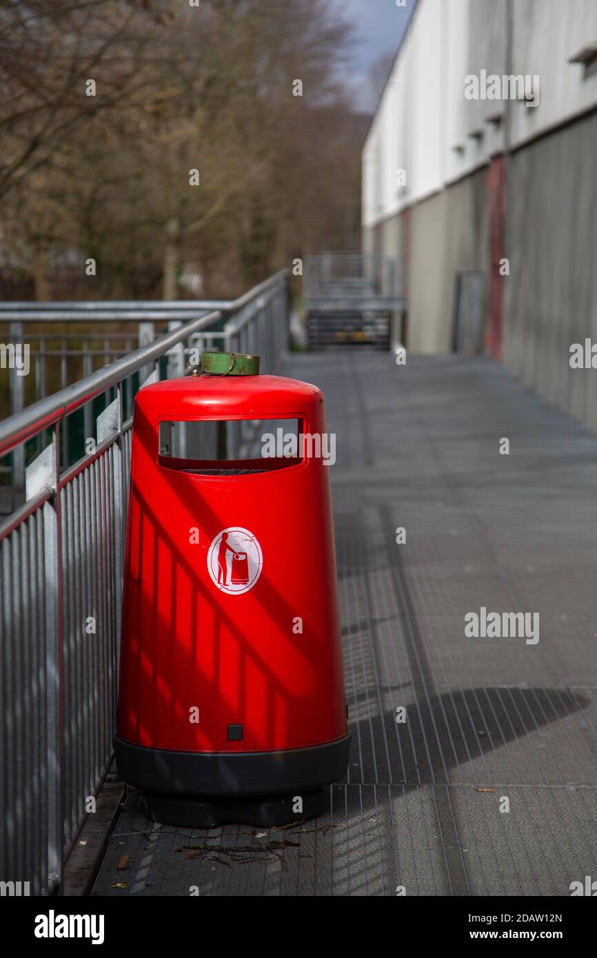 Vertical closeup of a red recycle bin in front of a building Stock ...