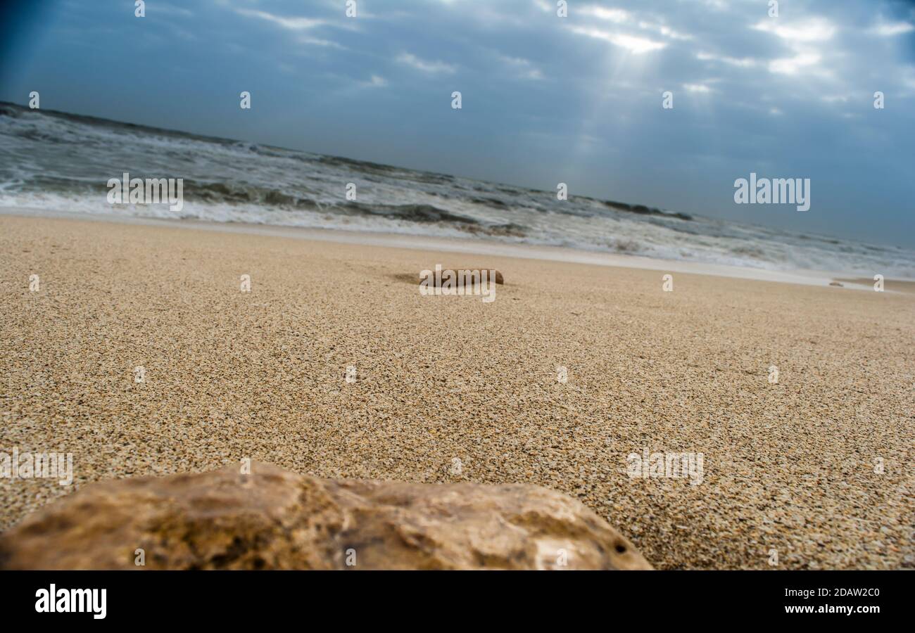 Sunshine pouring over the sea through the clouds view from beach of ...