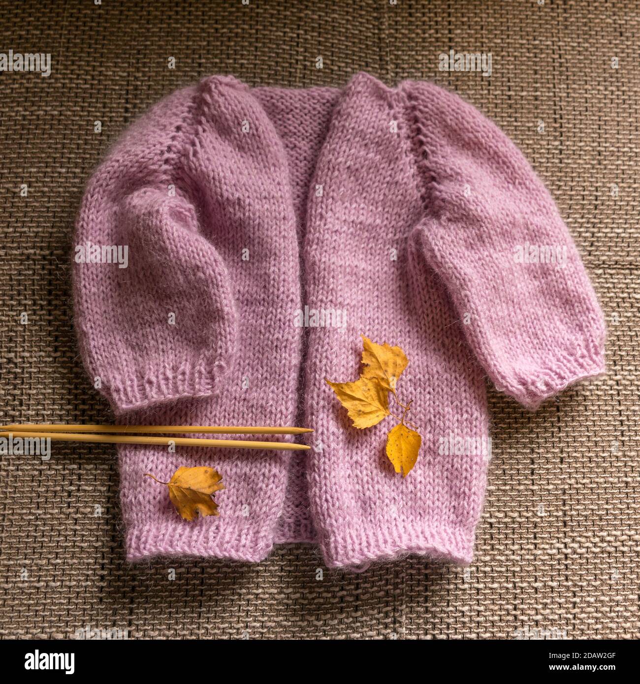 knitted jacket for a girl, pink color, knitting texture, handicraft ...