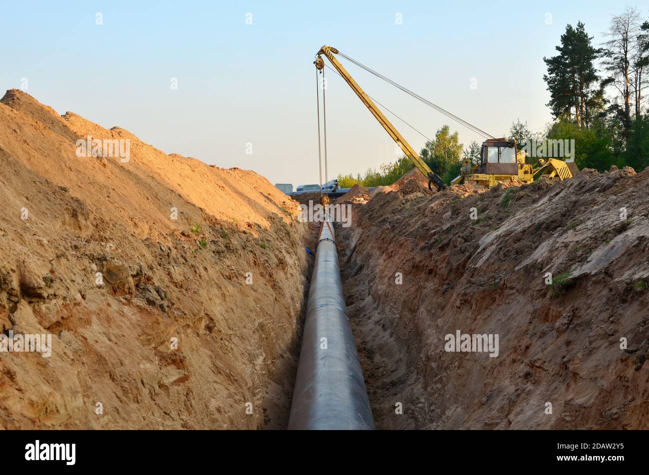 Natural gas pipeline construction work. A dug trench in the ground for ...