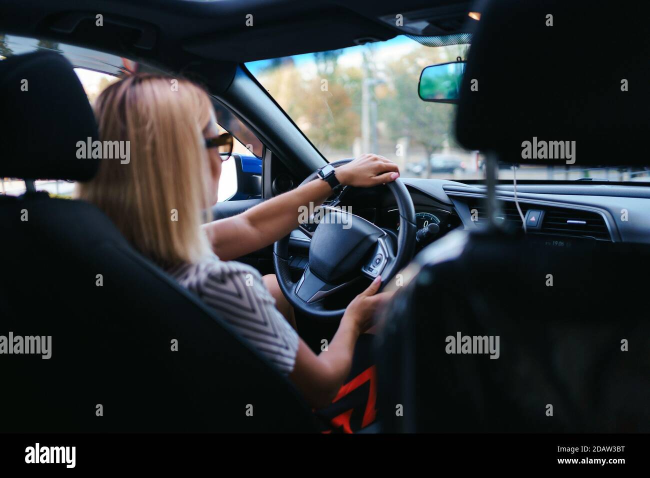 Confident and beautiful woman in sunglasses. Rear view of attractive ...