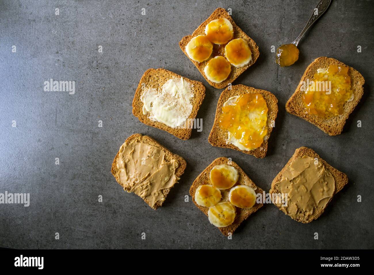 Sweet breakfast top view photo. Toasts with different toppings: peanut ...