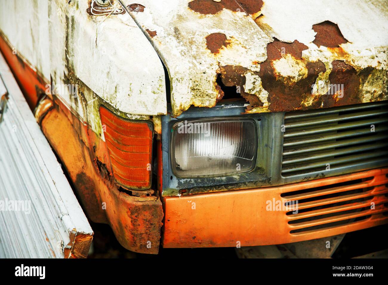 old rusty abandoned car on a city street Stock Photo - Alamy