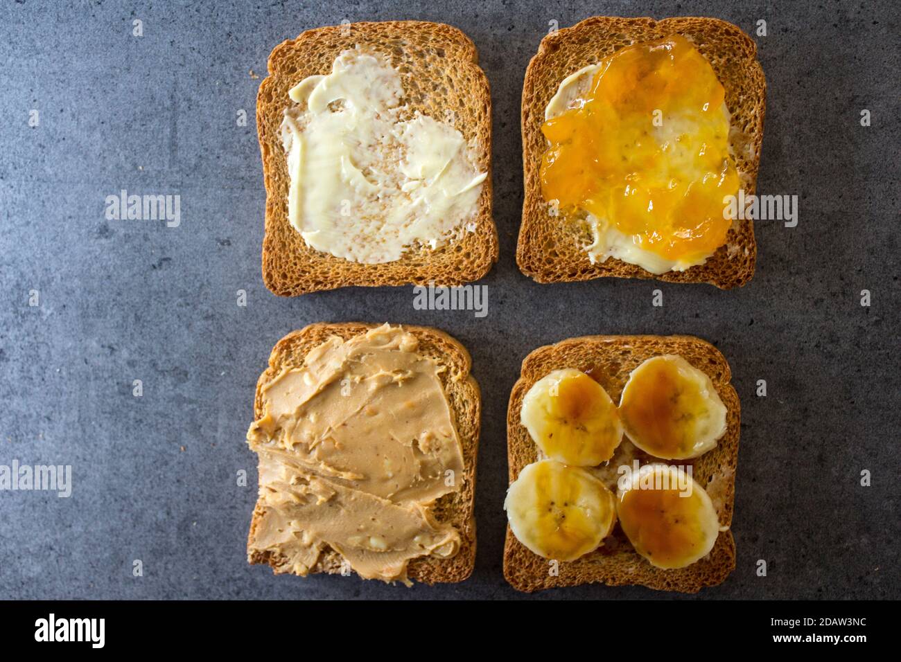 Sweet breakfast top view photo. Toasts with different toppings: peanut ...