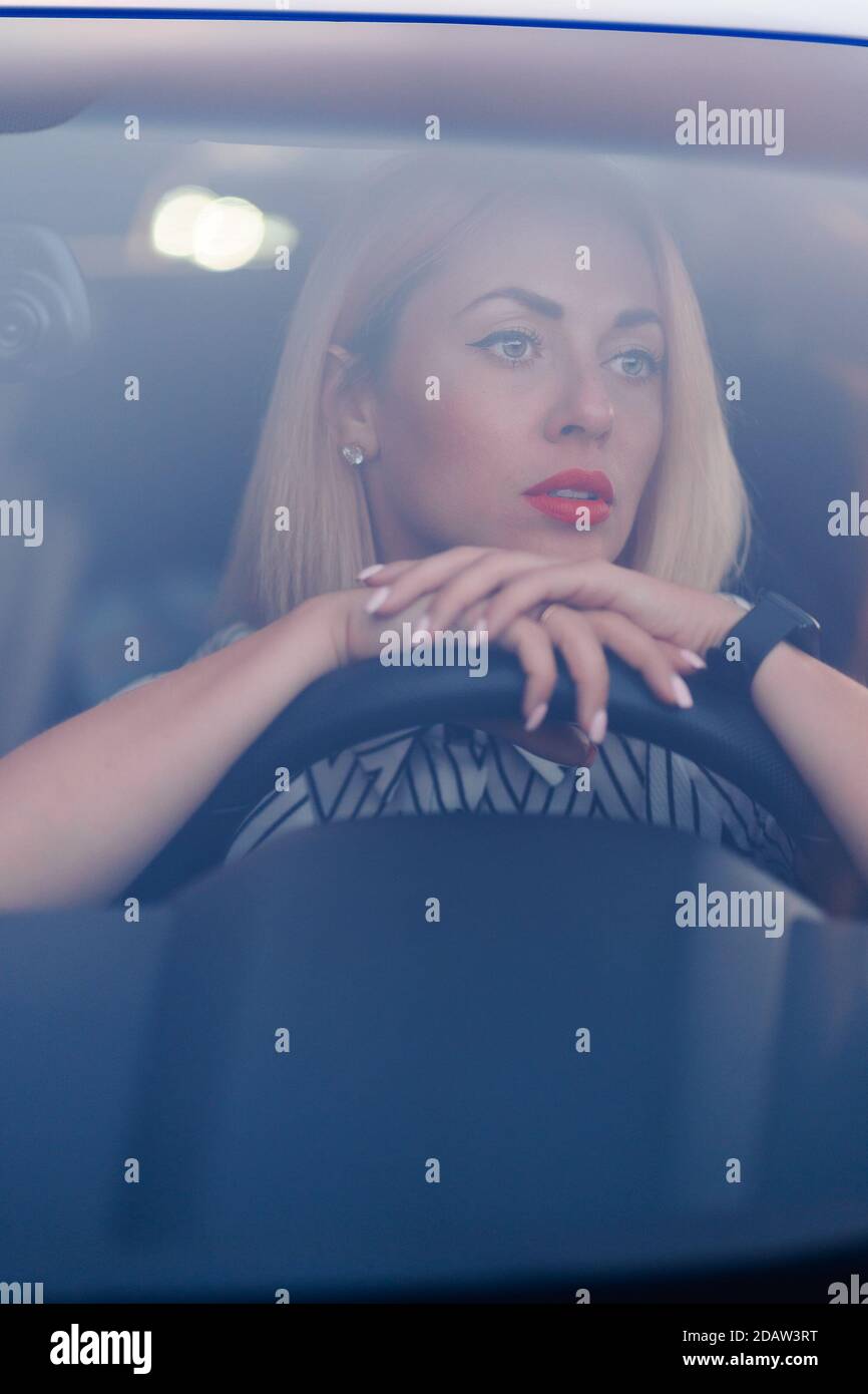 Young woman driver through windscreen hi-res stock photography and ...