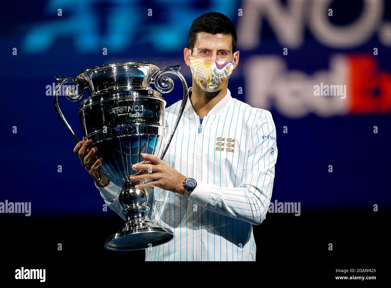 Novak Djokovic poses with his year end ATP number one trophy during day ...