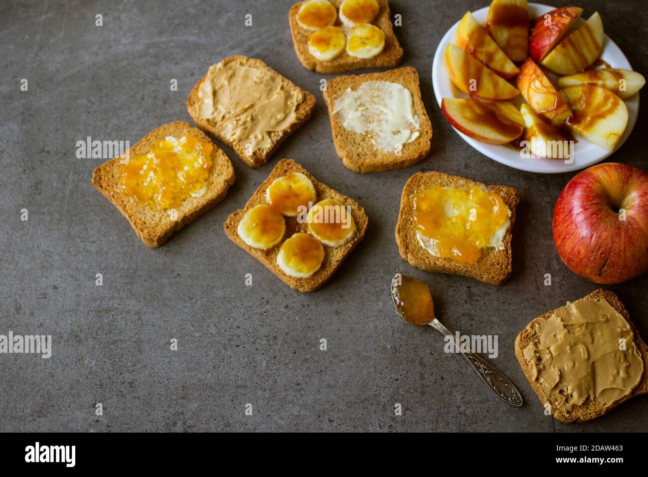 Sweet breakfast top view photo. Toasts with different toppings: peanut ...