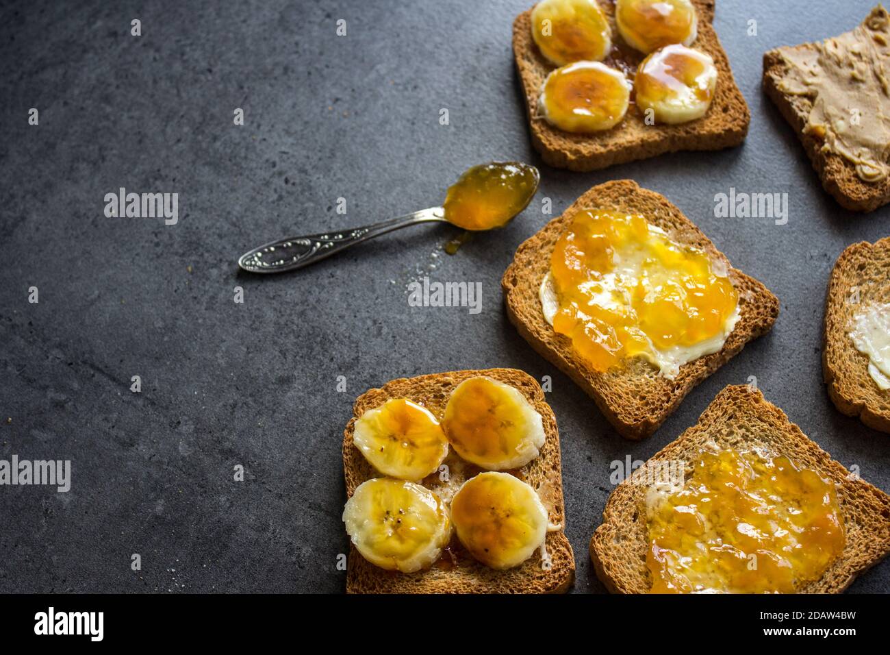 Sweet breakfast top view photo. Toasts with different toppings: peanut ...