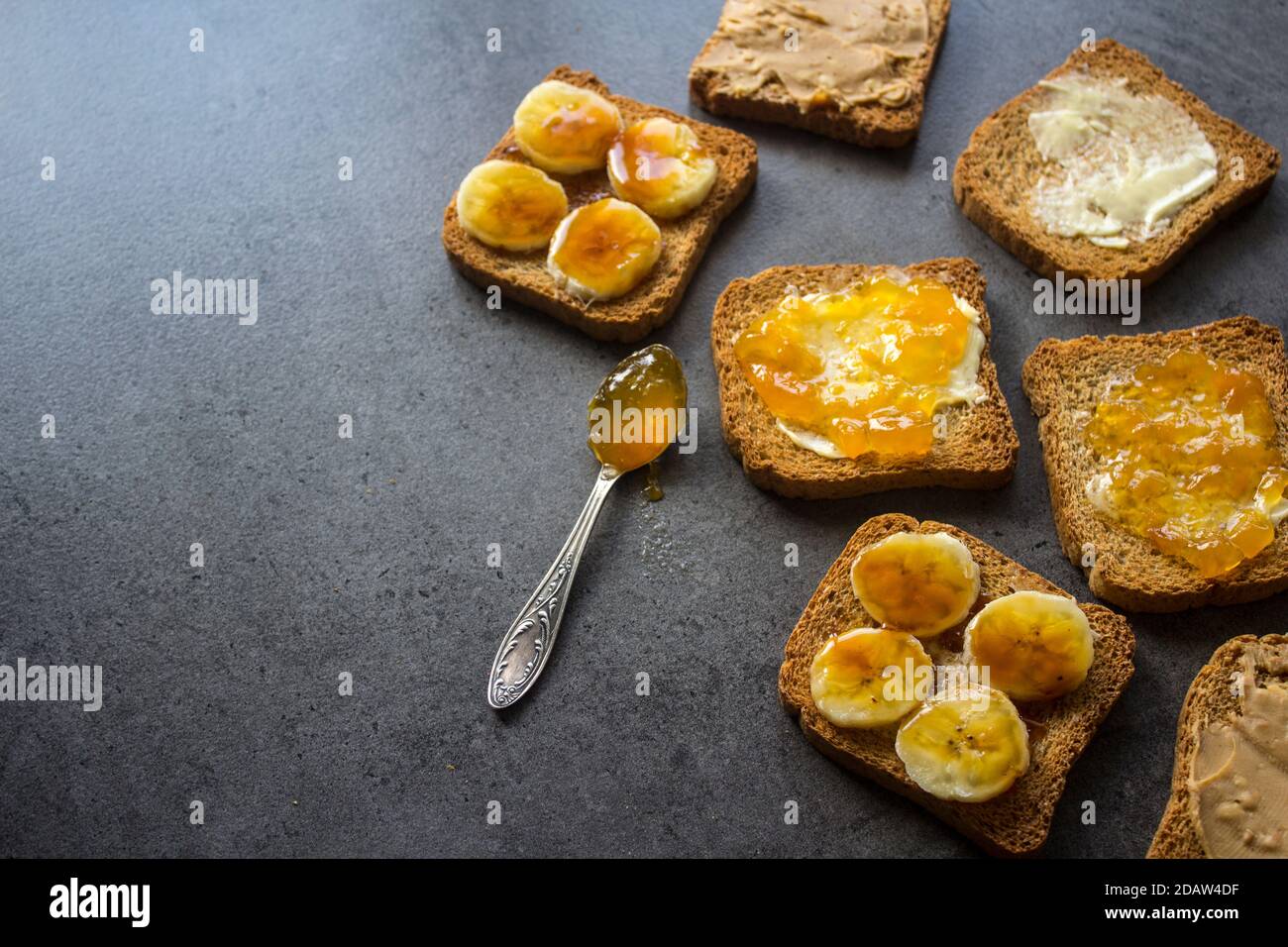 Sweet breakfast top view photo. Toasts with different toppings: peanut ...