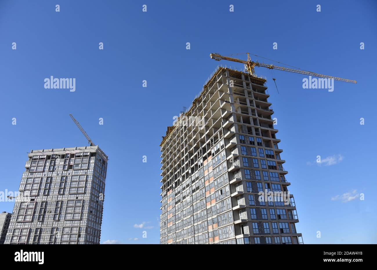 Tower cranes working at construction site on blue sky background Stock ...