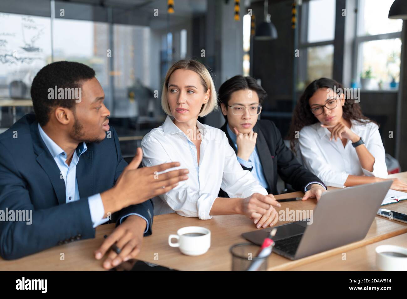 Multiethnic male female colleagues discussing hi-res stock photography ...