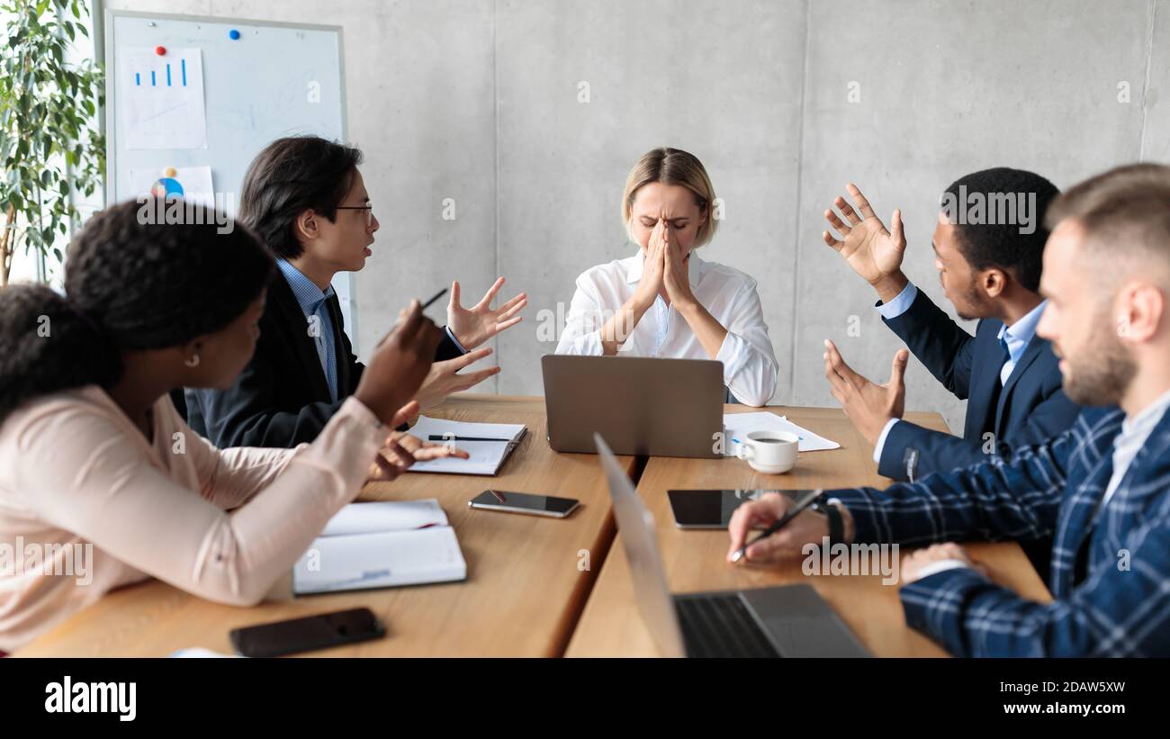 Aggressive Colleagues Shouting At Unhappy Business Lady In Office Stock ...
