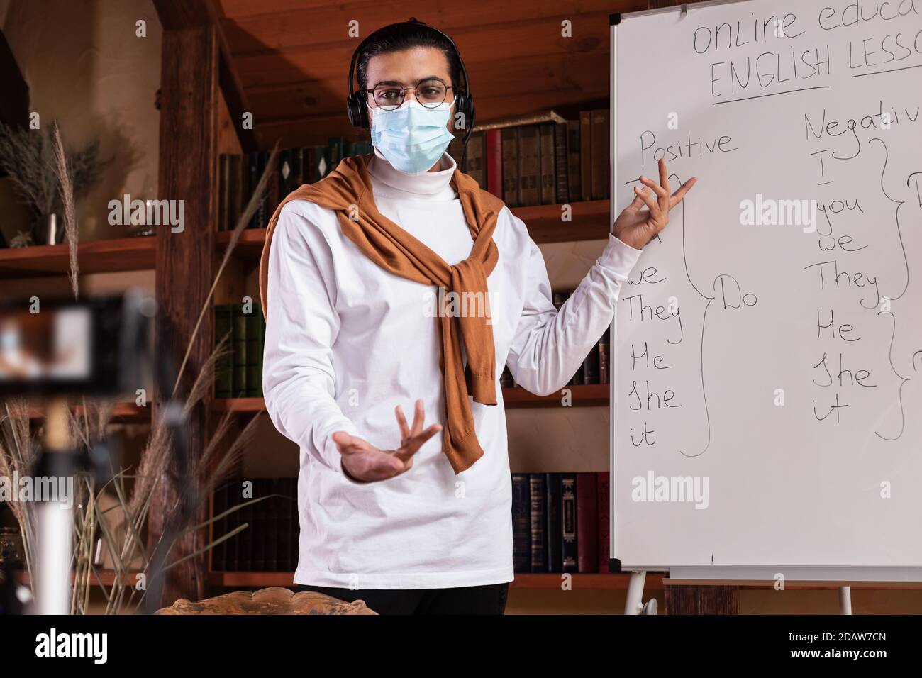 Teacher In Mask Making Video Lecture Pointing At Blackboard Indoor ...