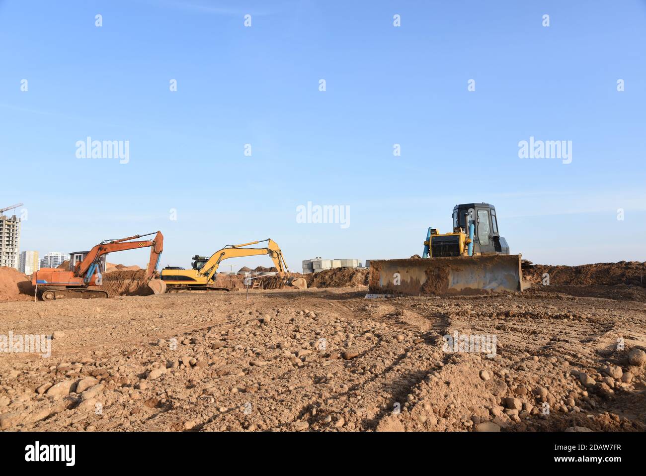 Excavators and dozer digs ground at a construction site for installing ...