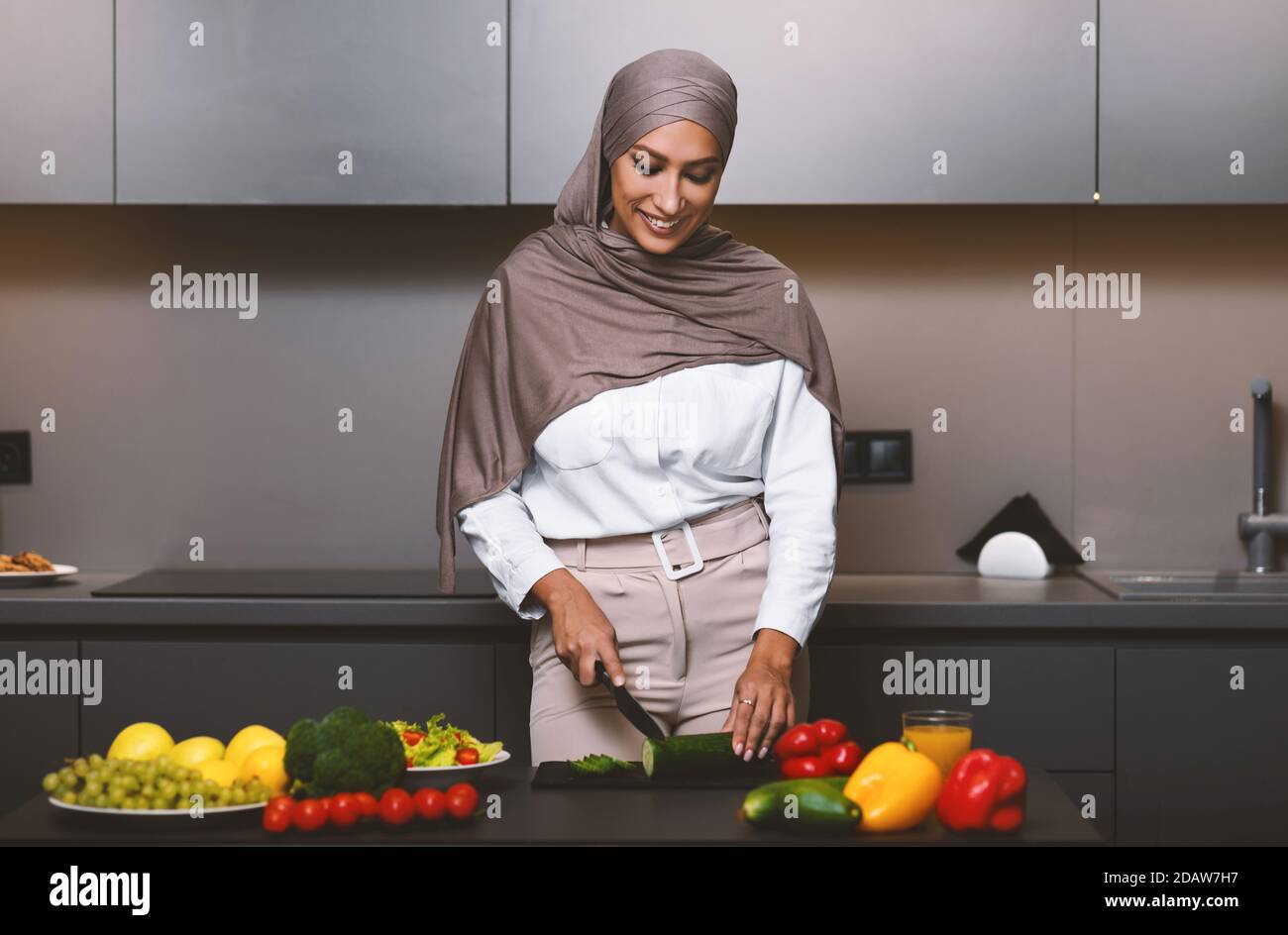 Muslim Wife Cooking Dinner In Modern Kitchen At Home Stock Photo - Alamy