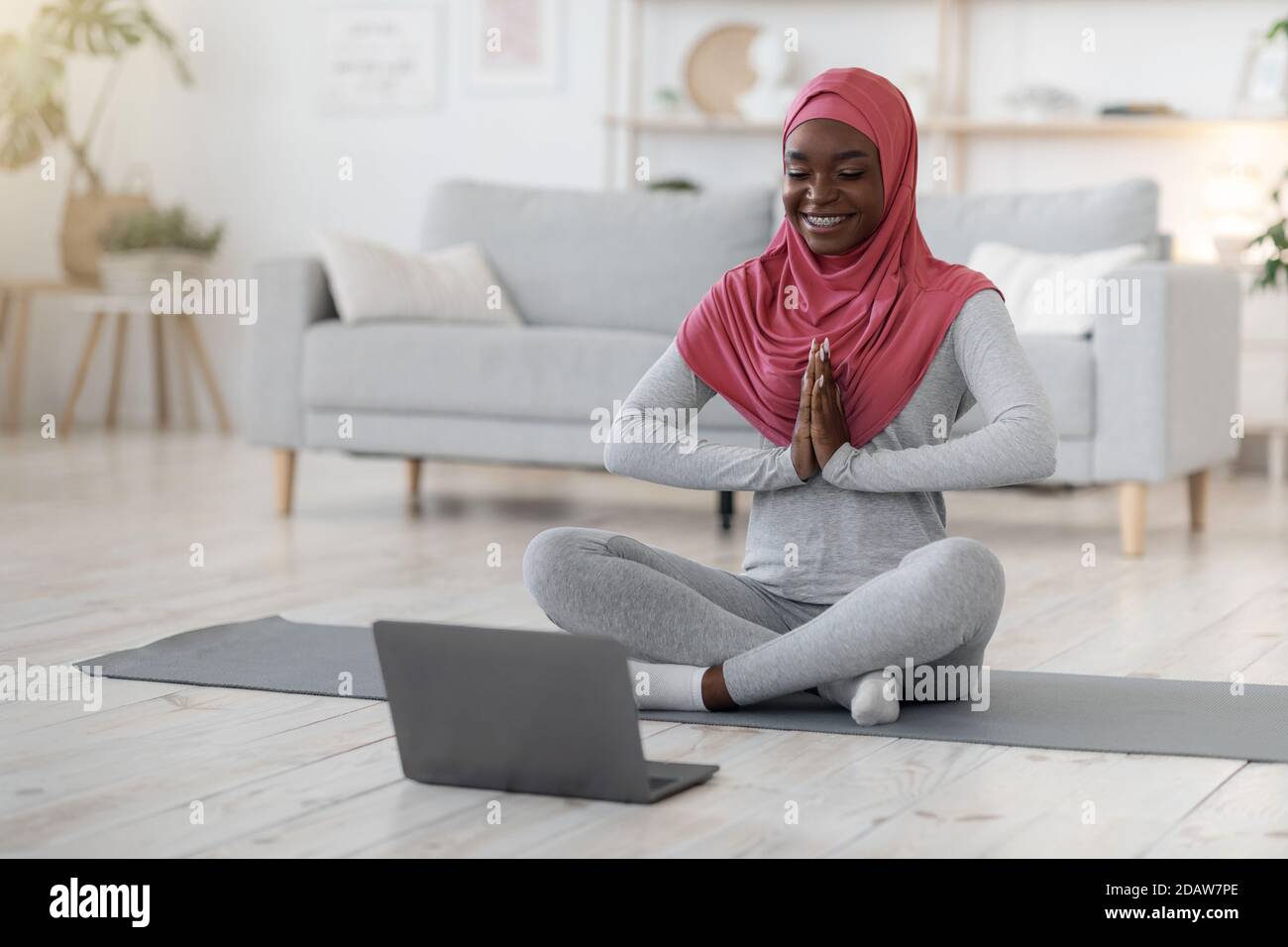 Home Training. Black Muslim Lady In Hijab Meditating In Front Of Laptop ...