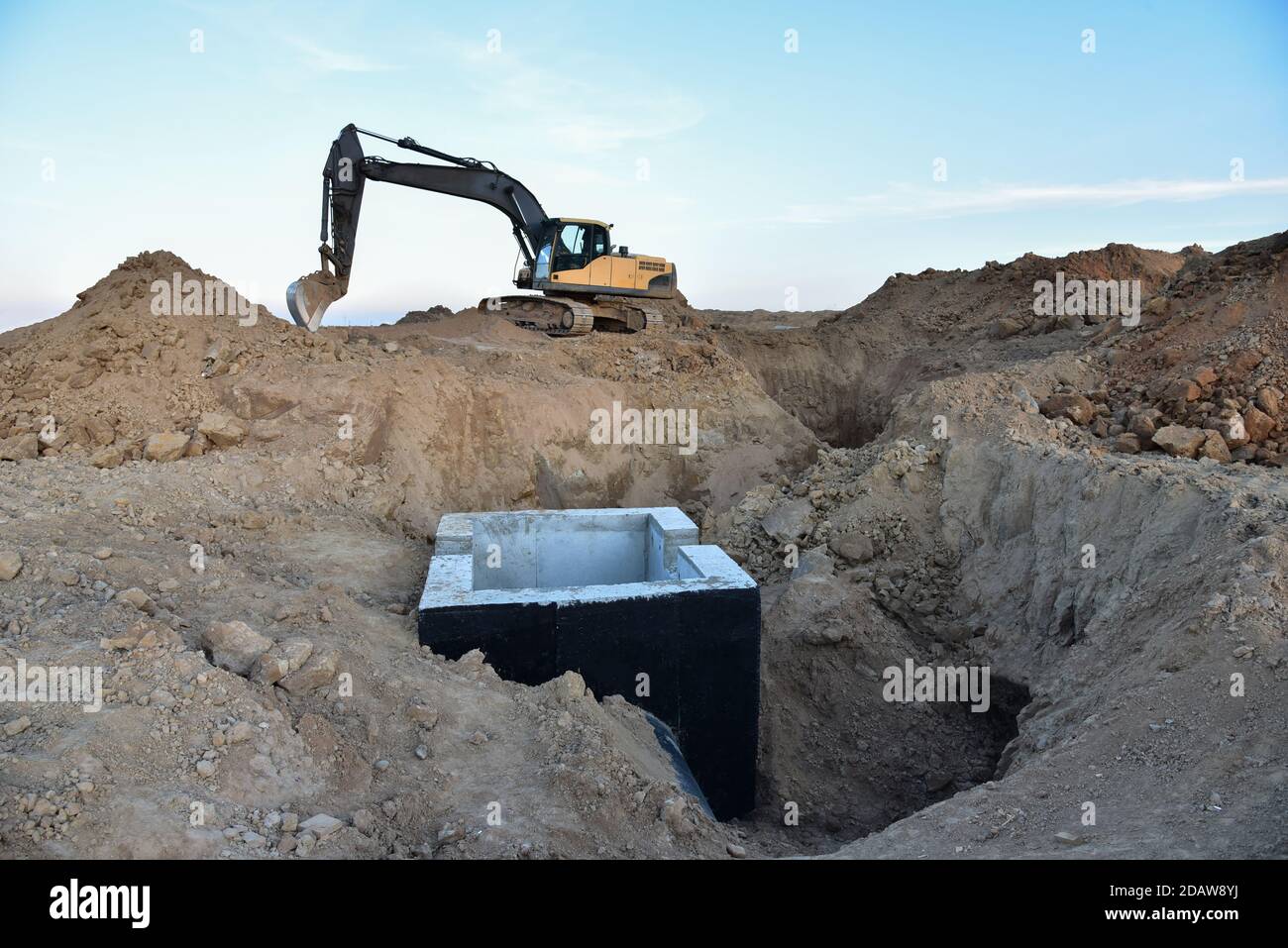 Excavator working at construction site on earthworks. Backhoe digs ...