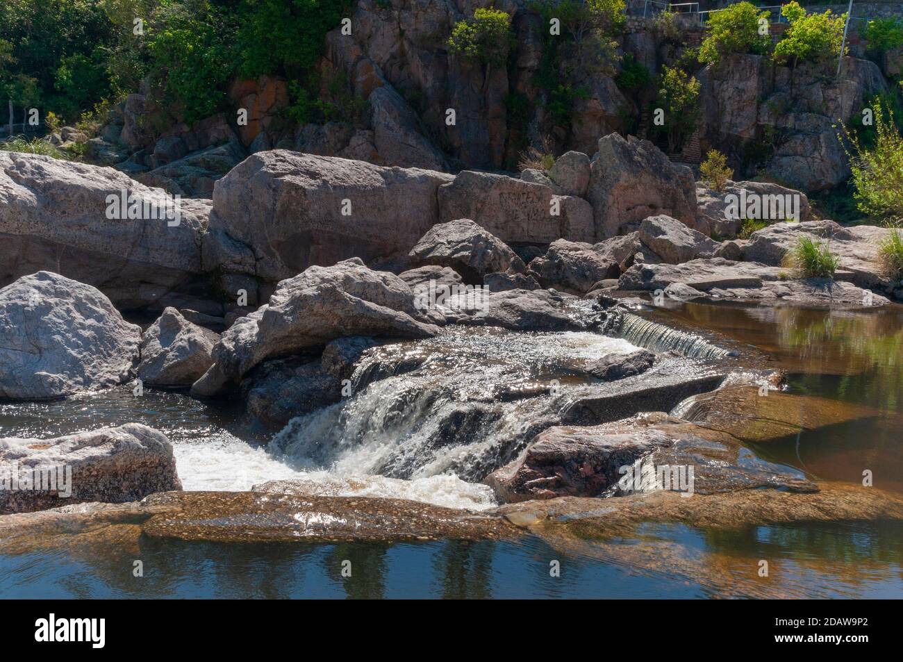 Rocks by the river surrounded by trees Stock Photo - Alamy