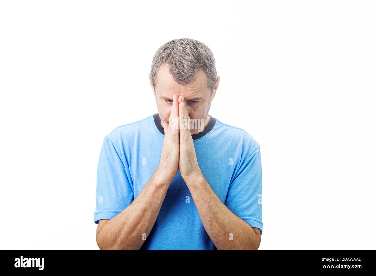 Depressed middle aged man praying over white background. Middle aged ...