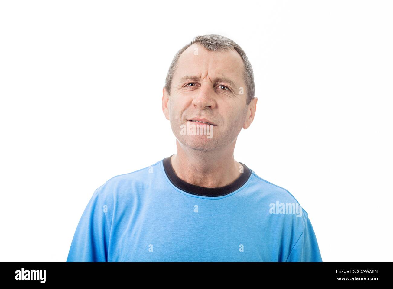 Perplexed middle age man feeling grumpy over white background. Portrait ...