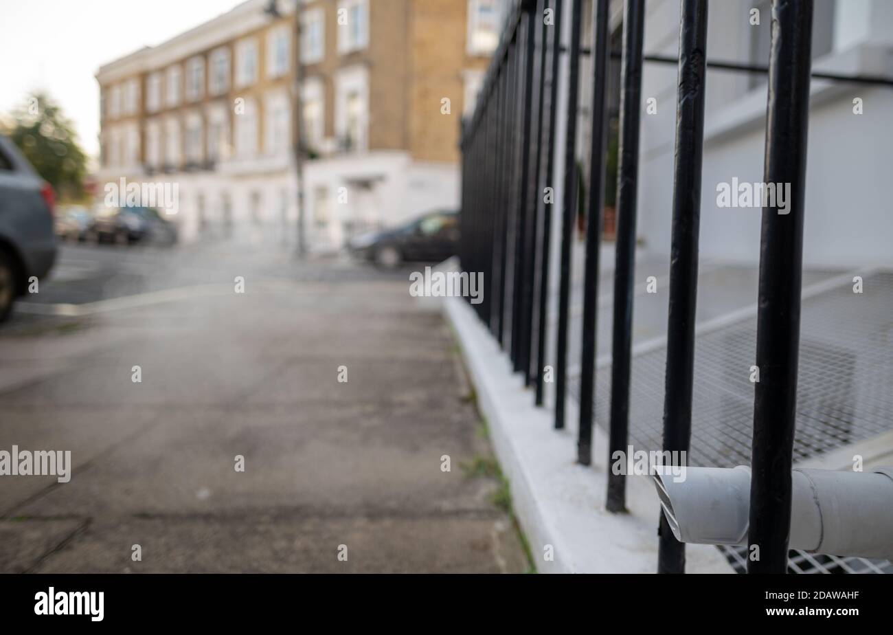 Steam appearing from a external building pipe at from a low level with ...