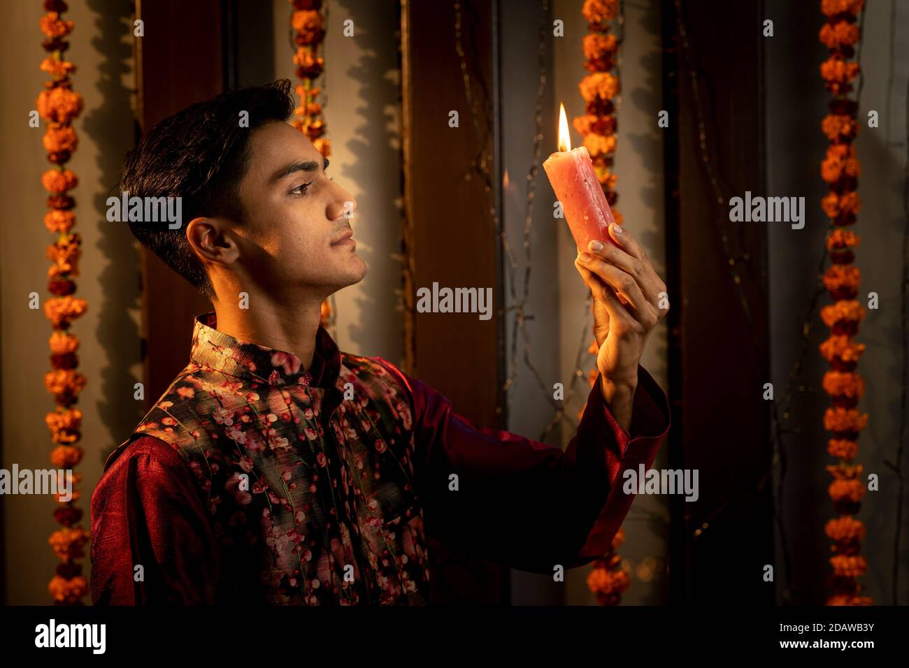 Portrait of an Indian man holding diyas and lamps on the festive ...